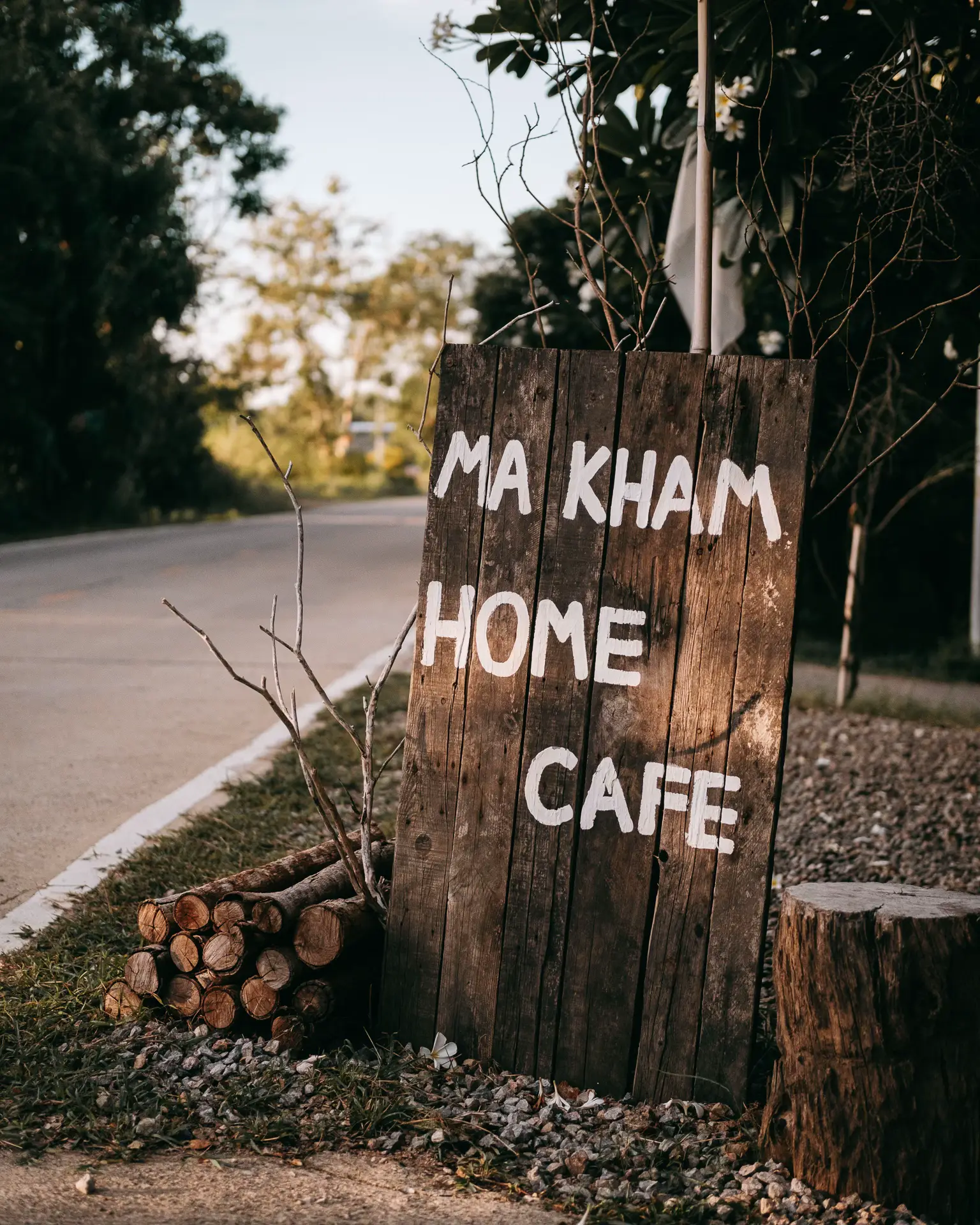 Ma-kham Home Cafe, a small cafe on a wide courtyard, under a big ...