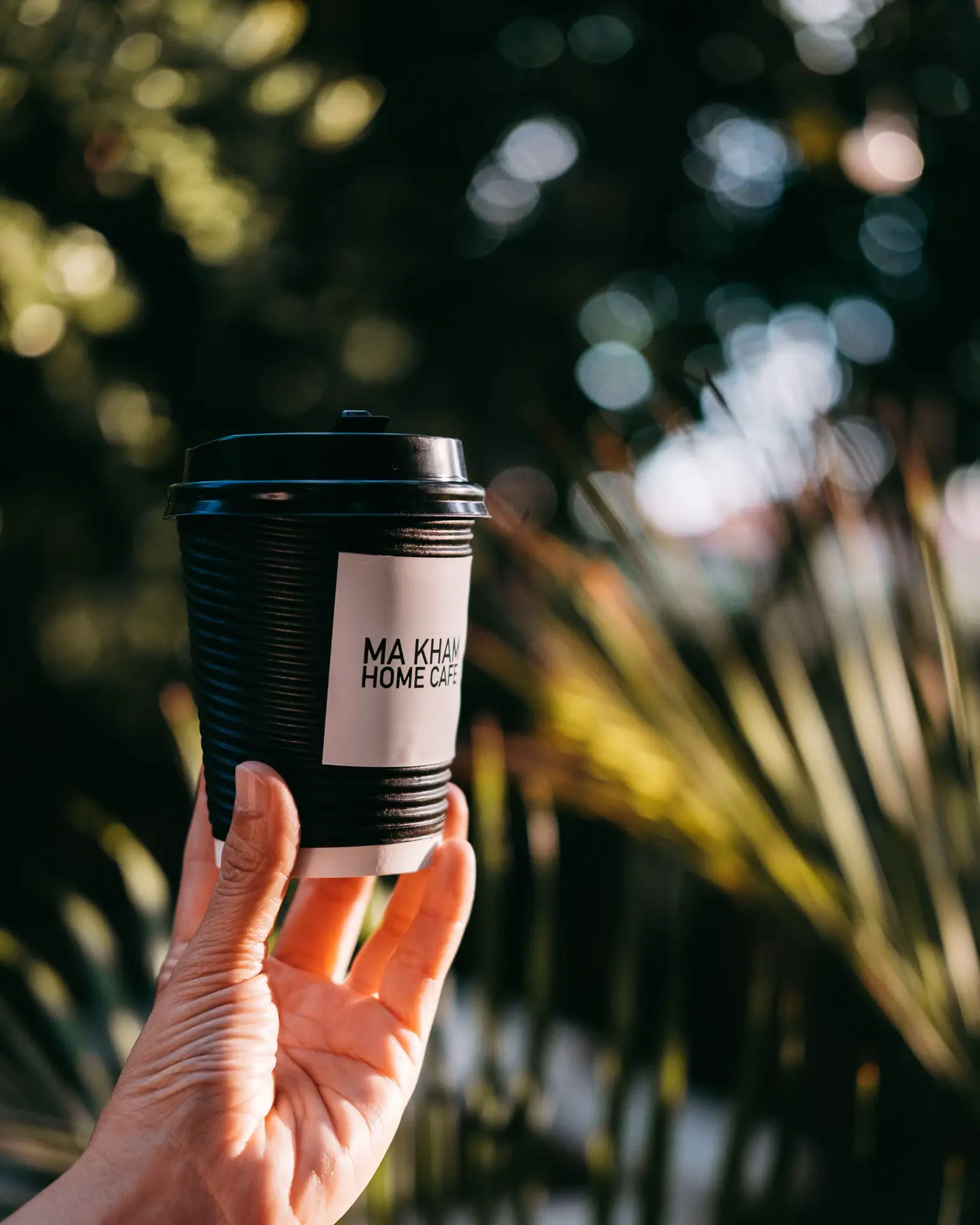 Ma-kham Home Cafe, a small cafe on a wide courtyard, under a big ...