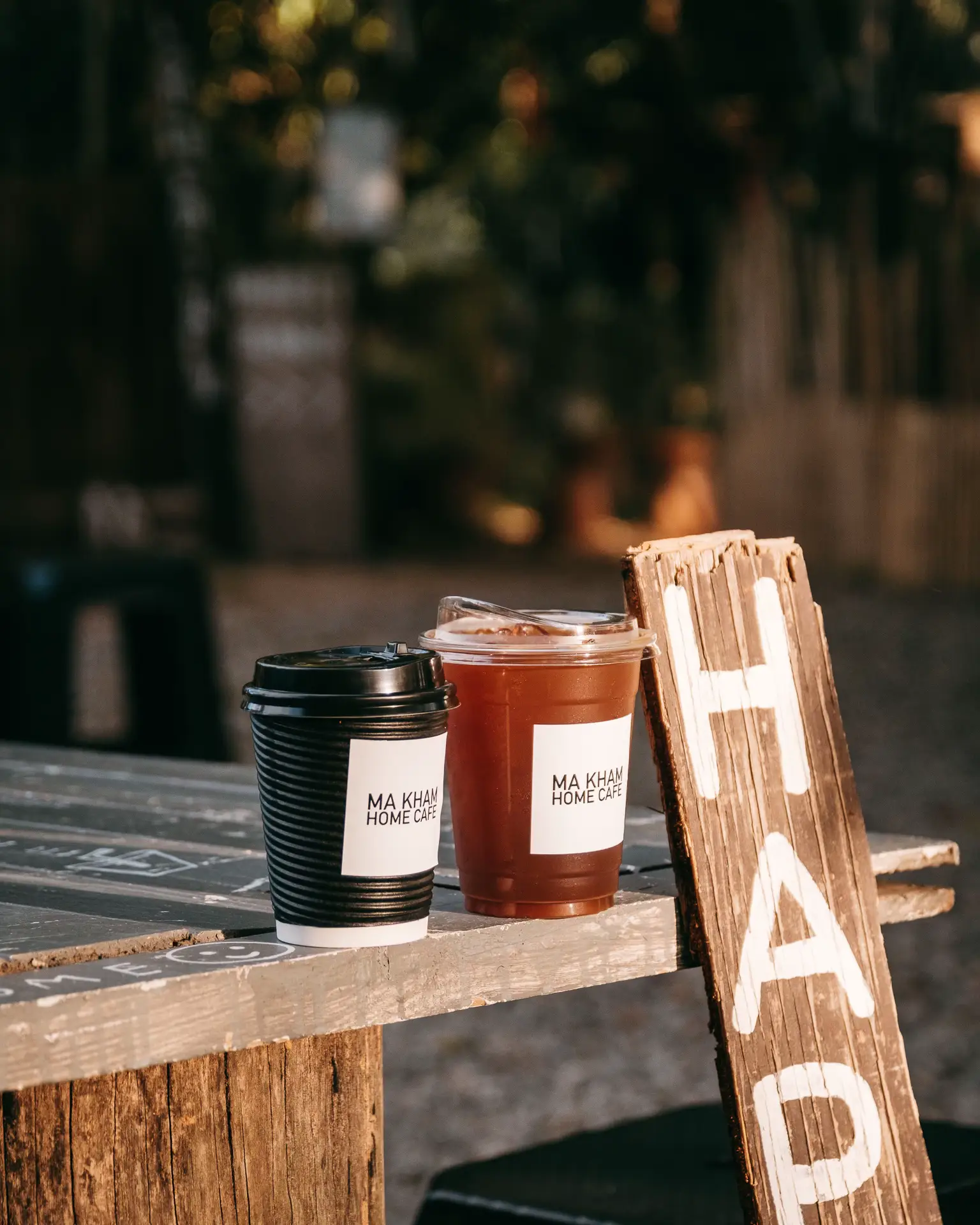 Ma-kham Home Cafe, a small cafe on a wide courtyard, under a big ...